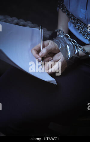 Kidnapped man sitting on chair with tied hands Stock Photo - Alamy