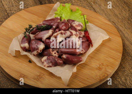 Raw chicken hearts heap with thyme branch Stock Photo - Alamy