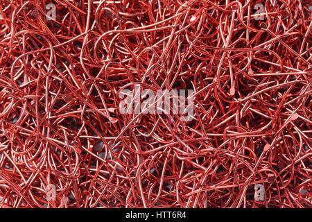 Pile of red Fish Hook for the design background Stock Photo - Alamy