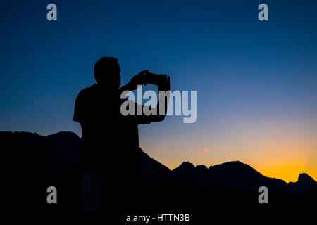 Man silhouette in the mountains with a smartophone in Basque Country ...