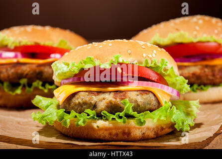 Fresh delicious burgers with meatball, cheese, tomato, onion, pickles ...