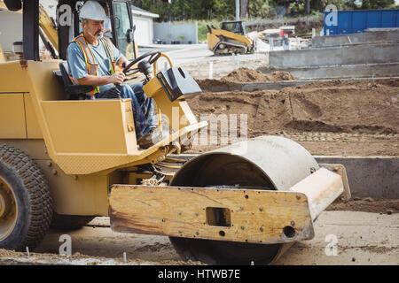 Man operating road roller Stock Photo - Alamy
