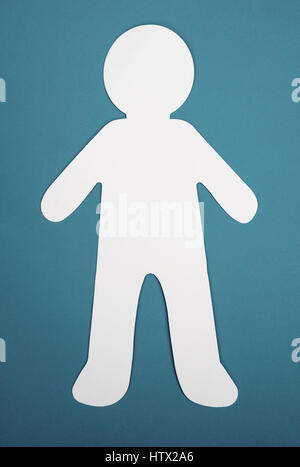 Man shape cut out of paper in notebbok in hand Stock Photo - Alamy