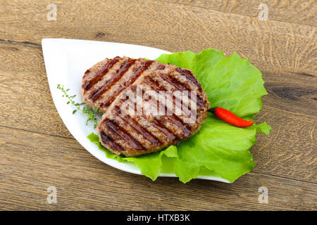 Grilled burget cutlet with pepper and salad leaes Stock Photo - Alamy