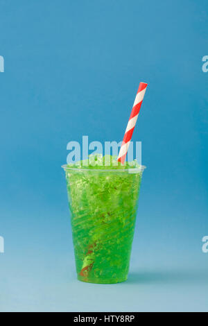 Green slushie. Blue background Stock Photo - Alamy