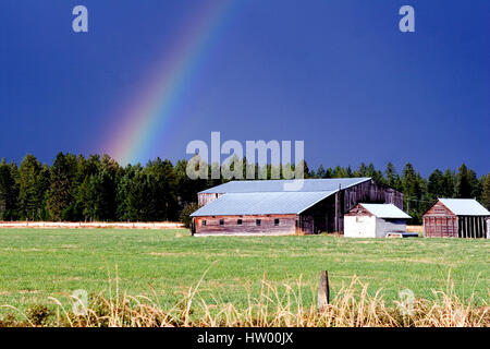 Landscape of a barn in a field with rainbow above it Stock Photo - Alamy