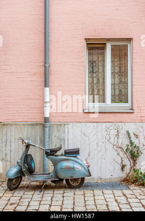 Abandoned rusted vintage old moped junk frame. Worn out and faded blue ...