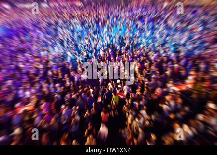 Blurred background with crowd of people partying and stage lights at a ...