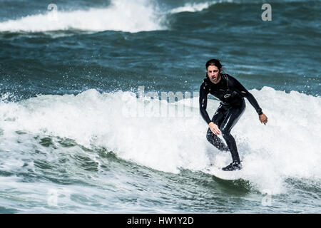 A surfer in Klitmoller which is a popular surfing destination in ...