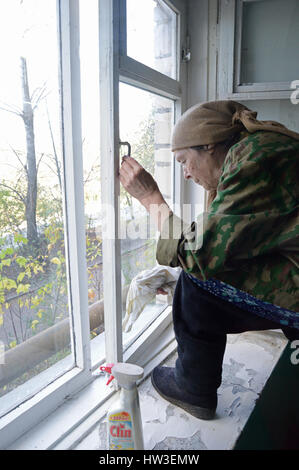Woman washes window in apartment Stock Photo - Alamy