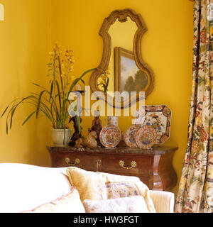 Interior of living room with chest of drawers, stool and houseplant ...