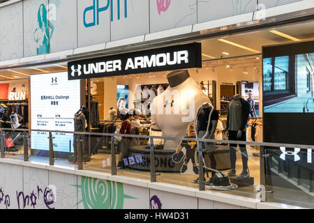 Large mannequin at Under Armour store and customers poking mannequin in ...