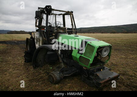 Burnt out old tractor Stock Photo - Alamy