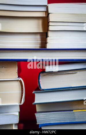 Stacked books on bright background Stock Photo - Alamy