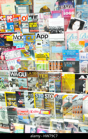 Newspapers and magazines on display on a shelf in a supermarket ...