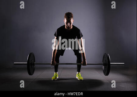 One handsom man lifting barbel. Crossfit fitness gym heavy weight bar ...