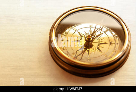 Vintage metal compass in toning light closeup Stock Photo - Alamy