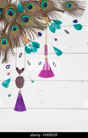 Green Jewelry and Peacock Feathers With Gold Picture Frame on Wooden ...