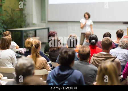 Woman giving presentation in lecture hall at university Stock Photo - Alamy
