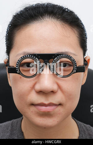 Asian Woman doing eye test Stock Photo - Alamy