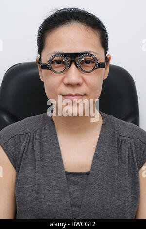 Asian Woman doing eye test Stock Photo - Alamy