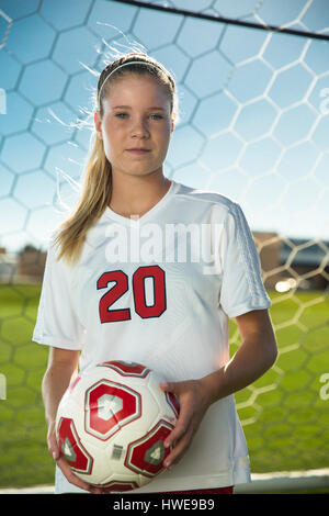 Goalie holding the soccer ball at the goal post Stock Photo - Alamy