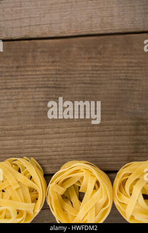 Fettuccine pasta arranged in a row on white background Stock Photo - Alamy