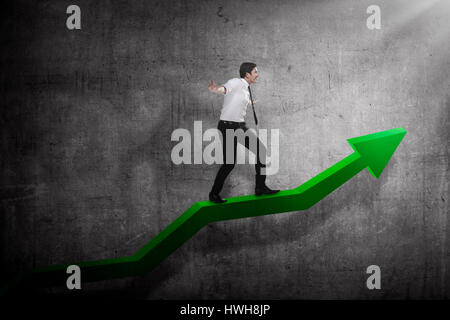 Asian business man balancing increasing arrow chart Stock Photo - Alamy