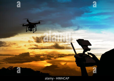 Male pilot controlling drone with remote control Stock Photo - Alamy