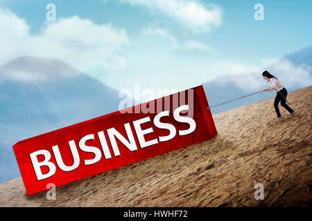 Business woman pulling block with business typing in Stock Photo - Alamy