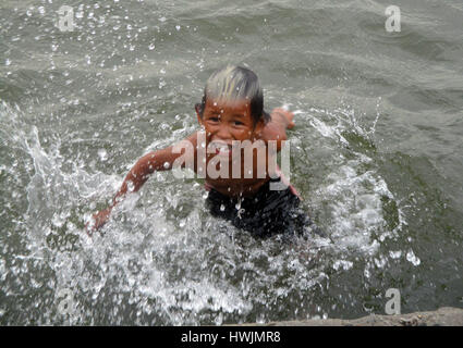 Manila, Philippines. 21st Mar, 2017. Filipino boys swim along the coast ...