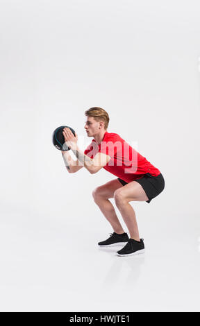 Handsome Nude Muscle Man Crouching in Fog in Studio Stock Photo - Alamy