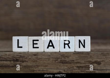 Learn written in wooden cubes on a desk Stock Photo - Alamy