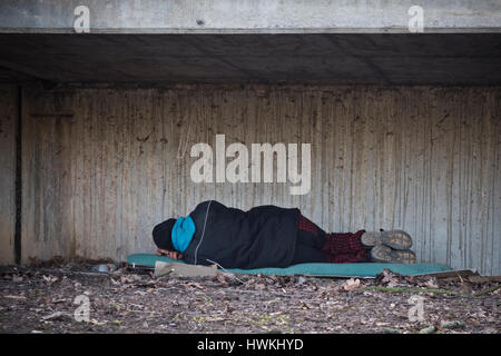 homeless man sleeping under a bridge Stock Photo - Alamy