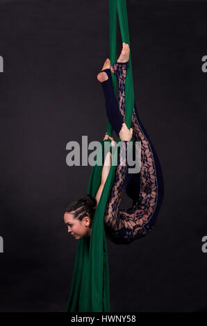 woman's aerial acrobatics in the paintings - dark background. Studio ...