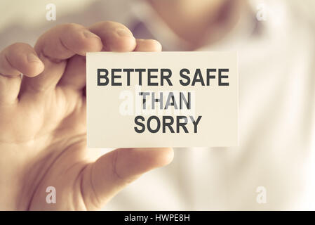 Better Safe Than Sorry Sign on white paper. Man Hand Holding Paper with ...