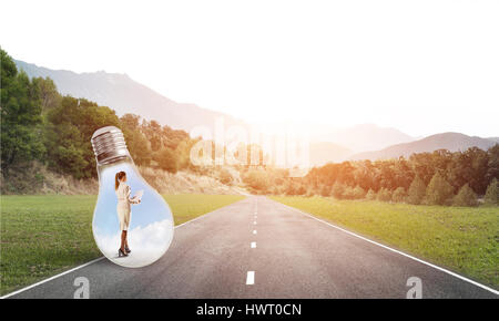 Businesswoman inside light bulb Stock Photo - Alamy