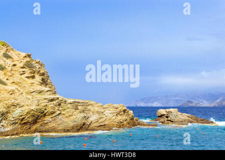 Waves break on the rocky shore of the Celtic Sea, top view. White foam ...