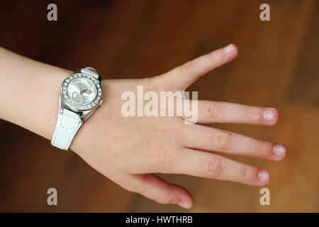 First Holy Communion: White watch on a childs wrist Stock Photo - Alamy