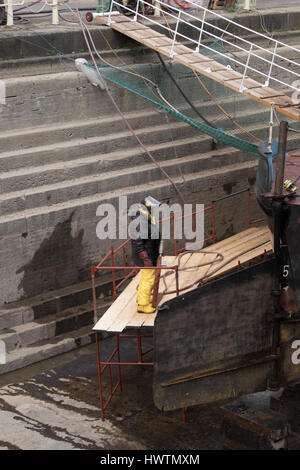 Cleaning the hull of unpowered barge Sabrina 5 in Gloucester drydock ...
