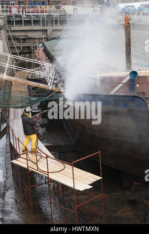 Cleaning the hull of unpowered barge Sabrina 5 in Gloucester drydock ...