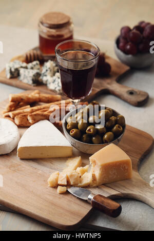 Camembert cheese close-up with honey, nuts, vine. Exquisite cheese ...