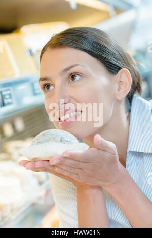 girl smelling a cheese Stock Photo - Alamy