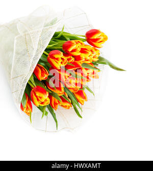 Bouquet of yellow and orange tulips wrapped in paper wrap. Fresh spring ...