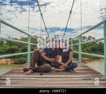 a couple on rope bridge Stock Photo - Alamy