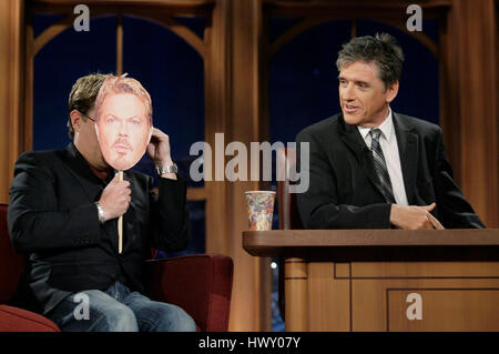 Eddie Izzard, left, chats with host Craig Ferguson with a mask of ...