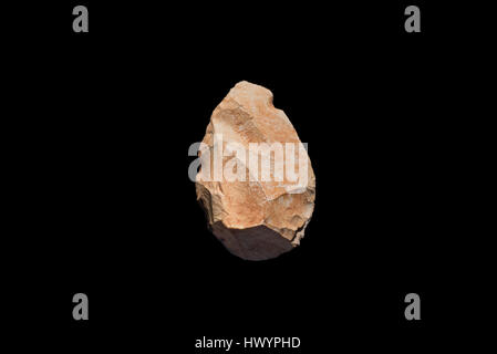 Prehistoric human tool, sandstone cleaver on black isolated background ...