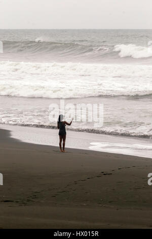 Indonesia, Java, woman at ocean coastline Stock Photo - Alamy