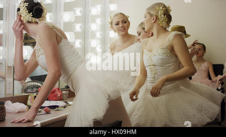 Serious ballet dancers in costume watching performance backstage during ...