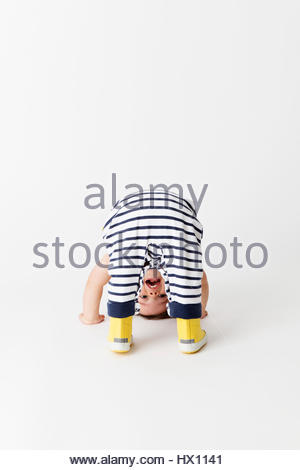 Toddler looking through legs Stock Photo: 3110302 - Alamy